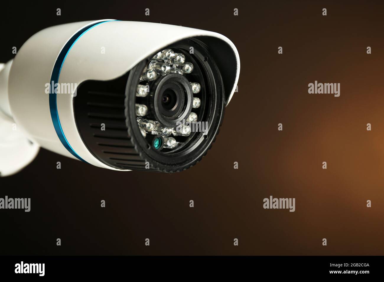 Security CCTV camera on dark yellow background, closeup Stock Photo - Alamy