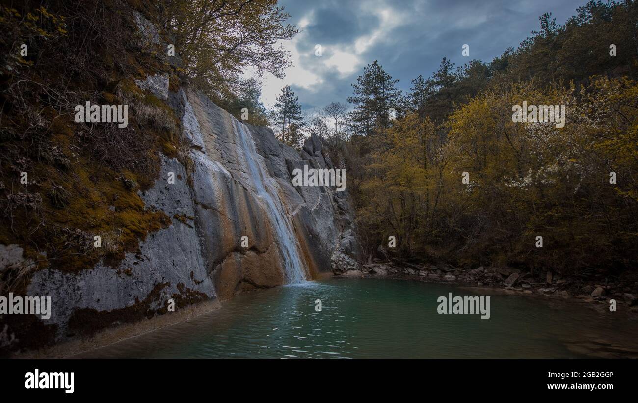 Beautiful waterfall on a sandstone rock formation in spring time, with ...
