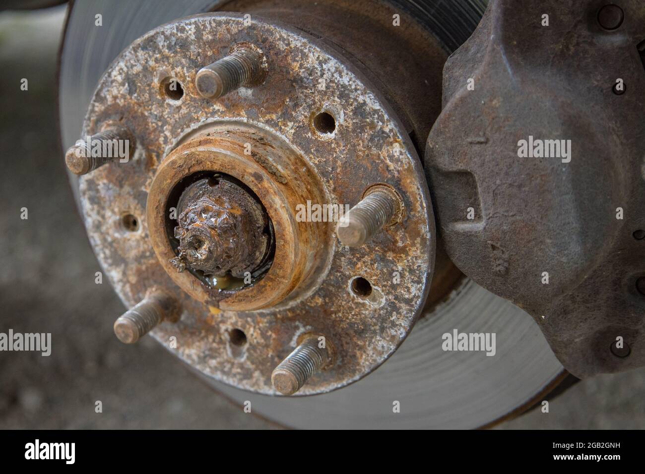 Opened steel hub of a car disk exposing bearing, pin, disk and brake ...