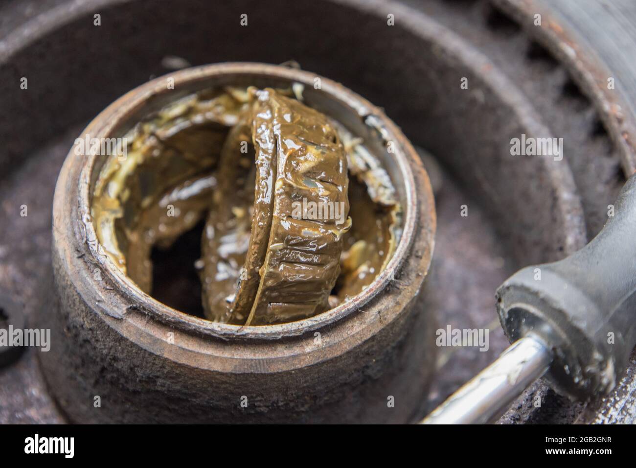 worn wheel bearing dirty and filled with muddy grease Stock Photo - Alamy
