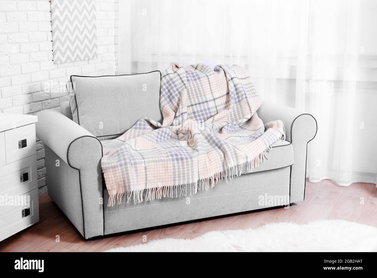 Interior with a modern sofa beside window Stock Photo - Alamy