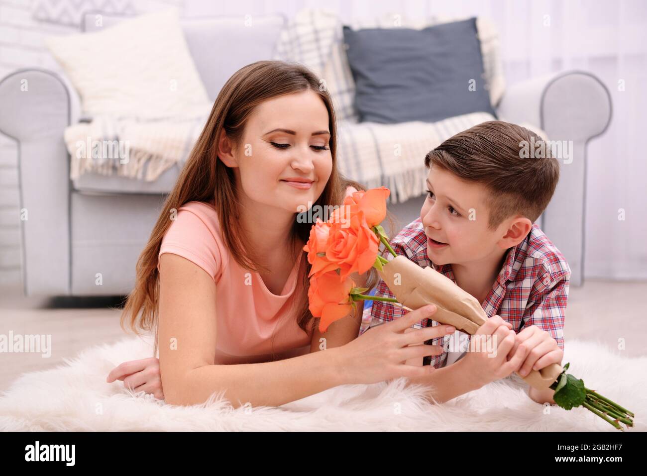 Son giving roses to his mother Stock Photo - Alamy