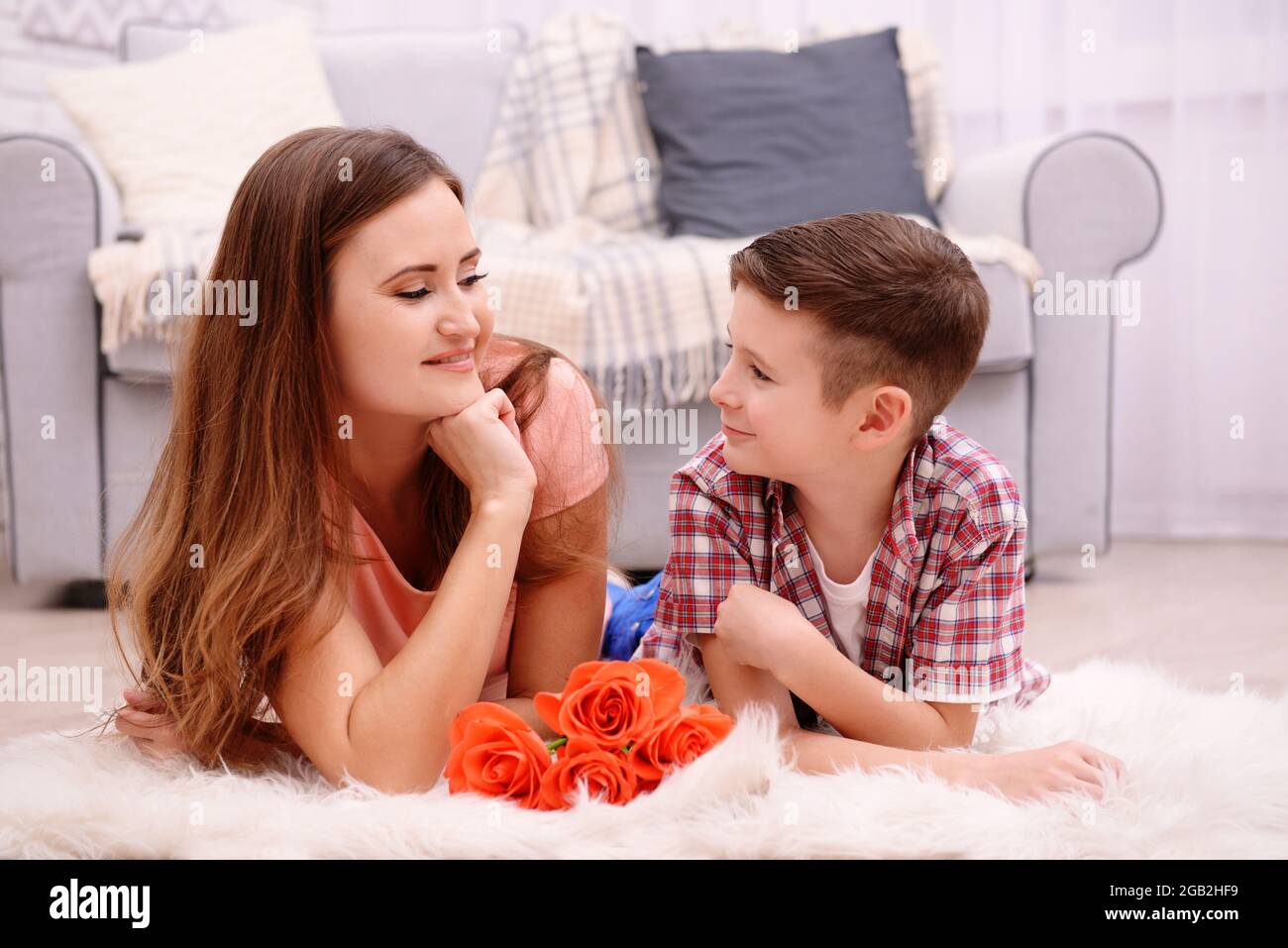 Son giving roses to his mother Stock Photo - Alamy