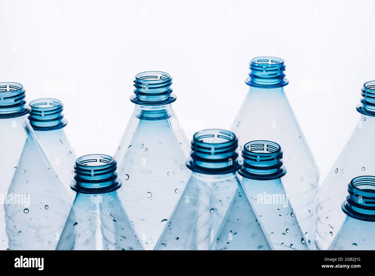 Used transparent plastic bottles on light blue background. Group of ...