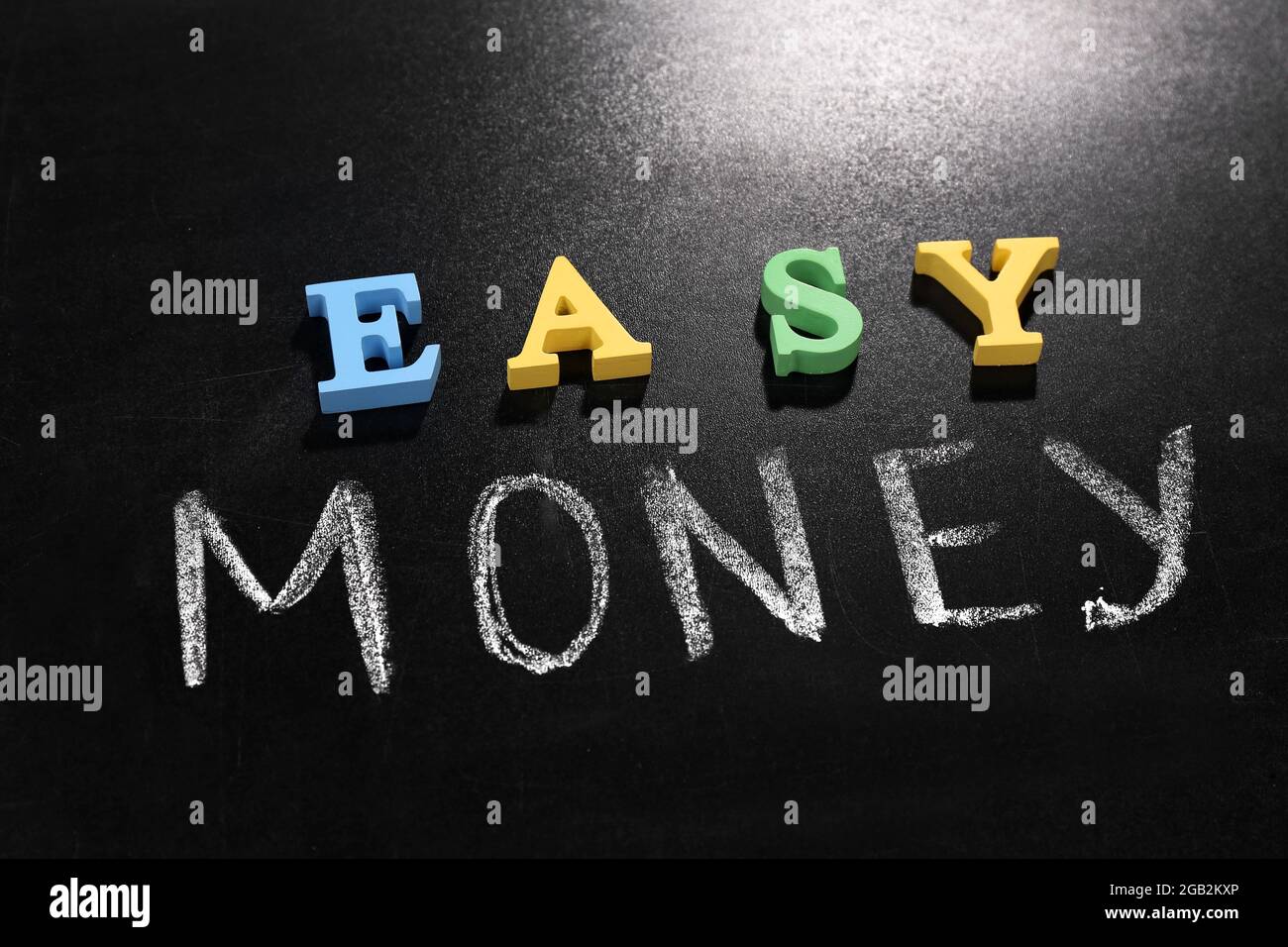 Easy money concept on a blackboard background Stock Photo - Alamy