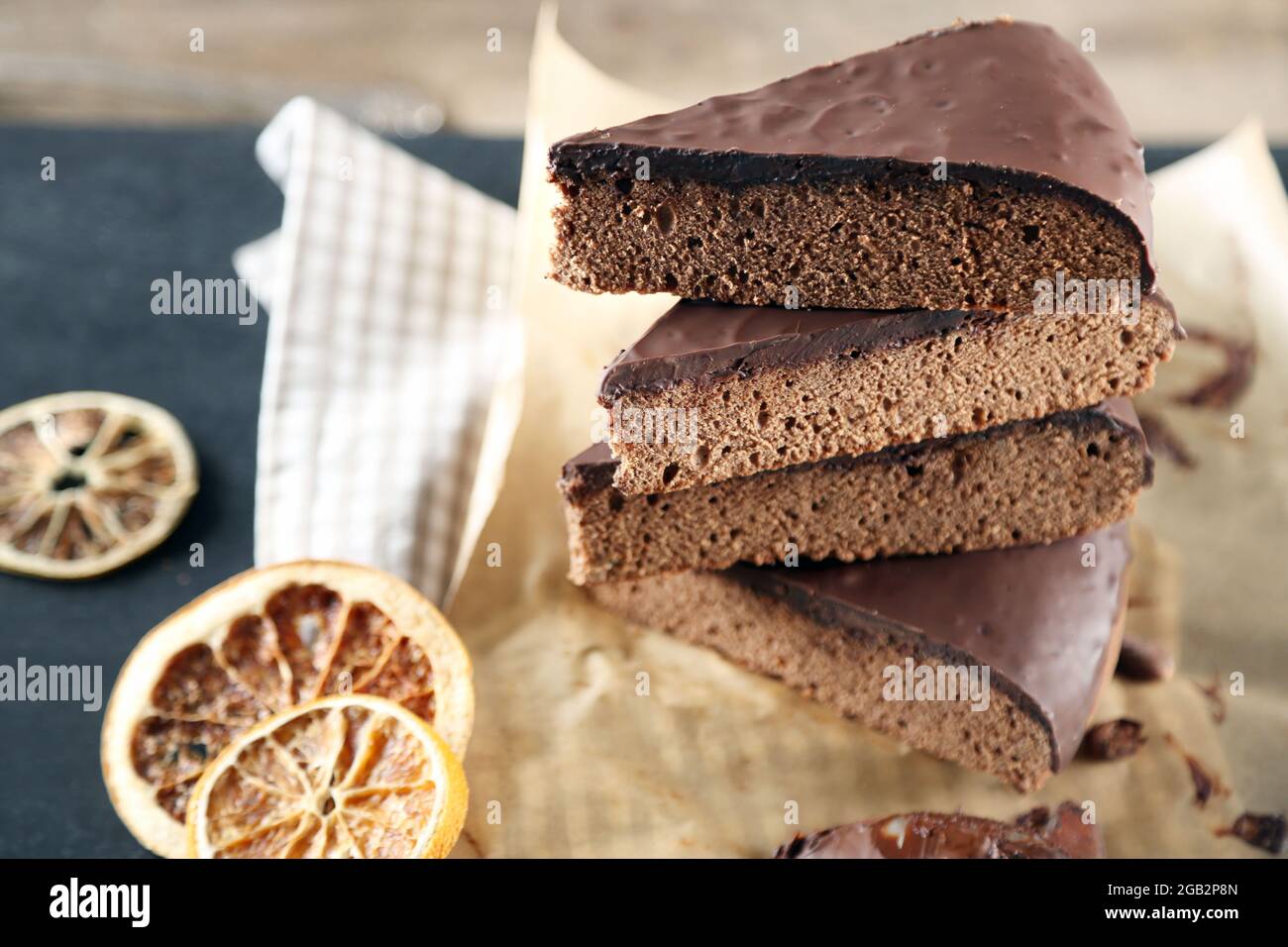 Pieces of frosting chocolate cake on parchment paper Stock Photo - Alamy