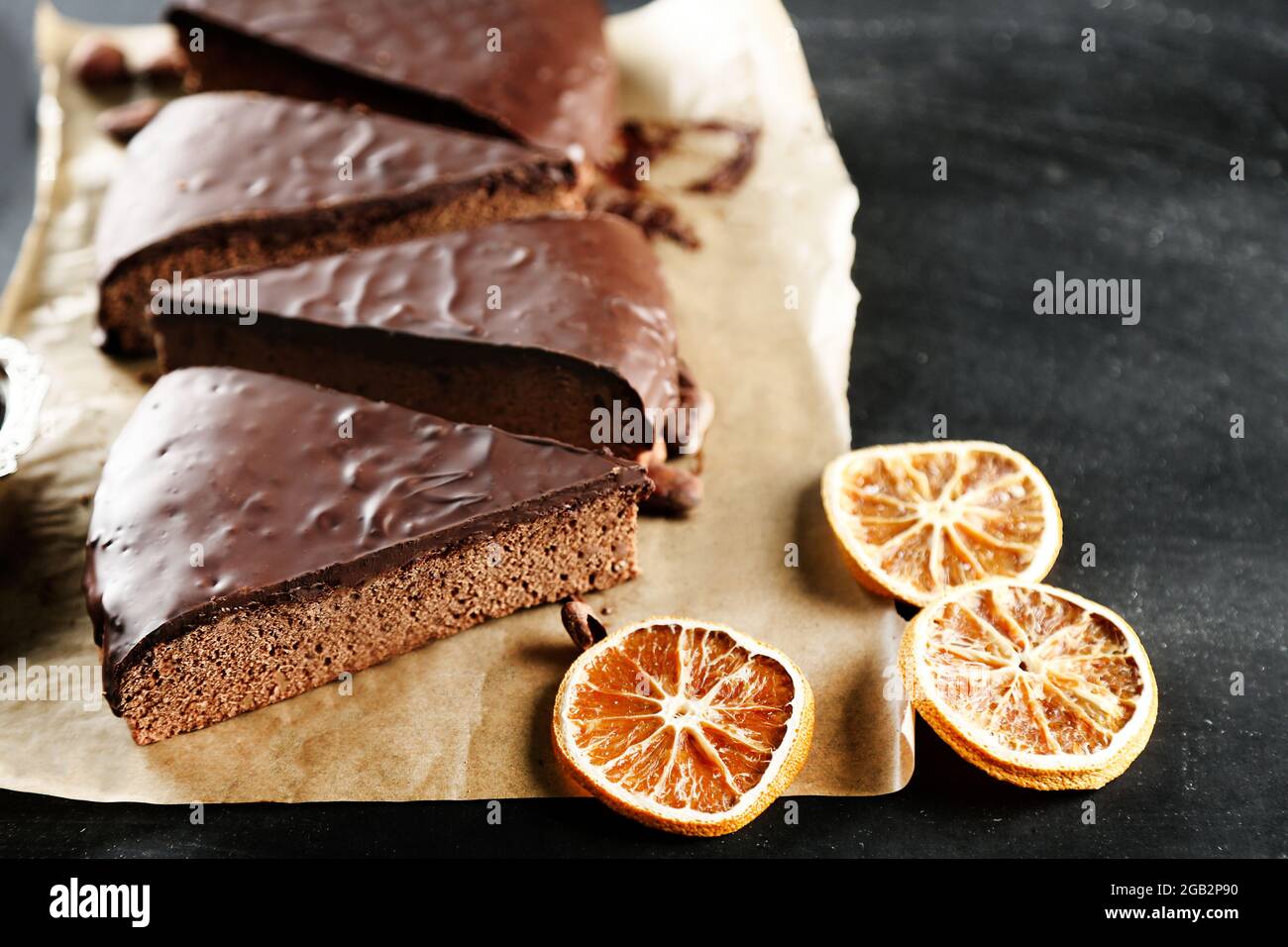 Pieces of frosting chocolate cake on parchment paper Stock Photo - Alamy