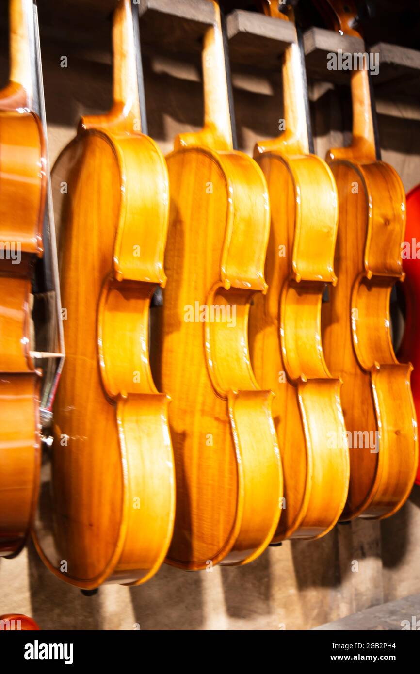 Many violins are hanging in a musical shop for ready to sell Stock ...