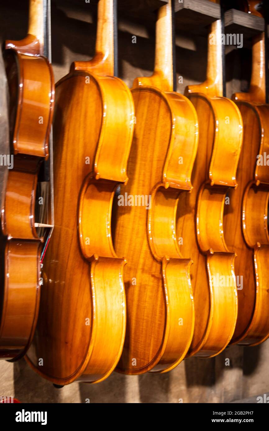 Many violins are hanging in a musical shop for ready to sell Stock ...