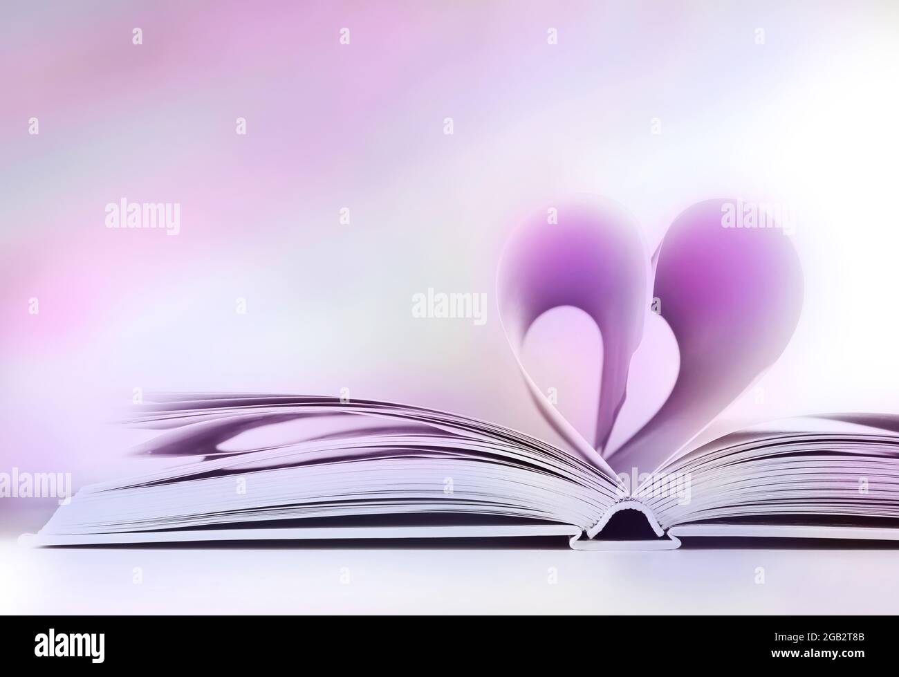 Heart from book pages on light grey background Stock Photo - Alamy