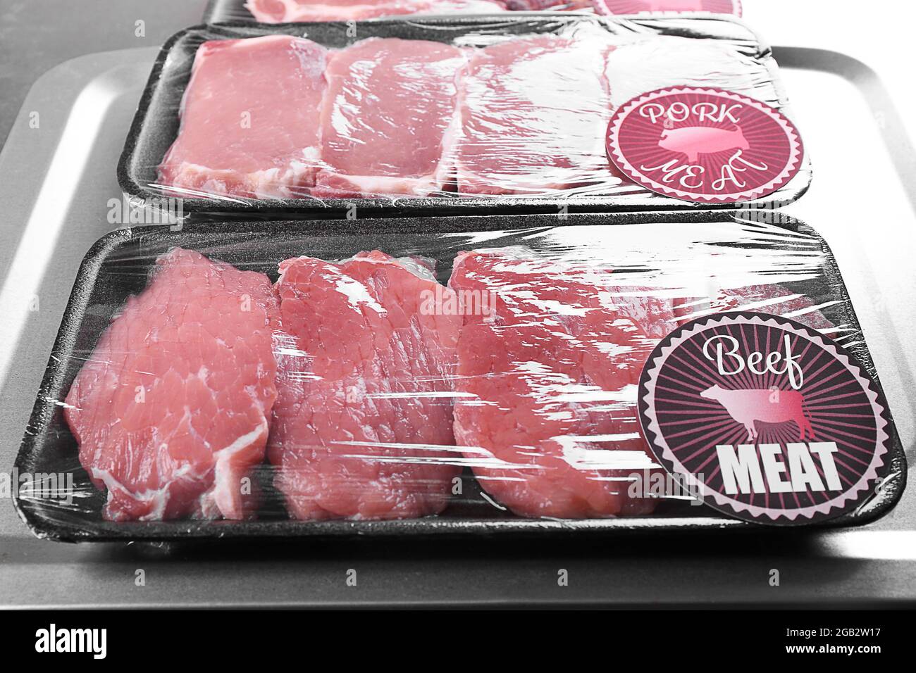 Packed pieces of pork and beef meat on metal background Stock Photo - Alamy