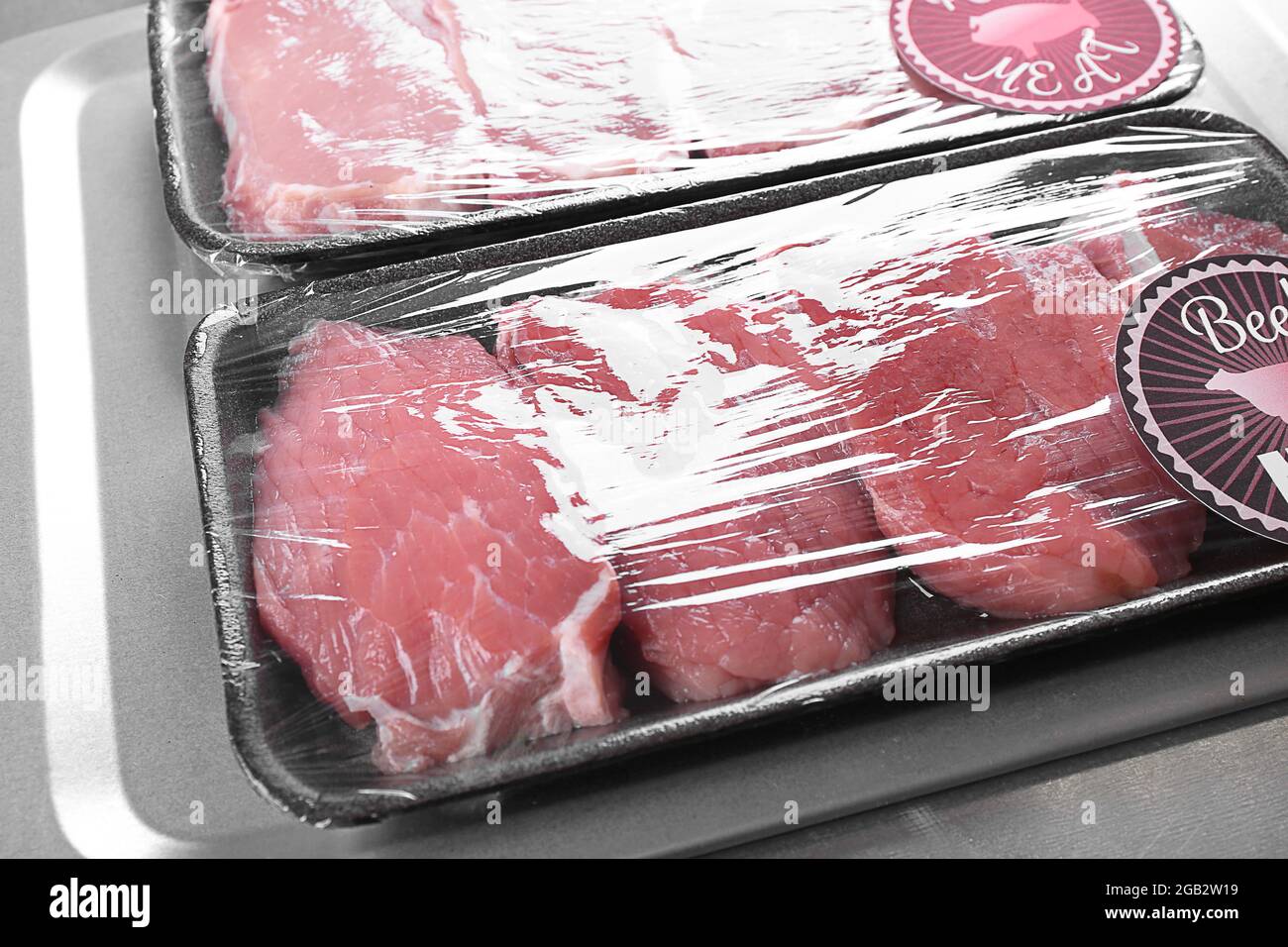 Packed pieces of pork and beef meat on metal background Stock Photo - Alamy