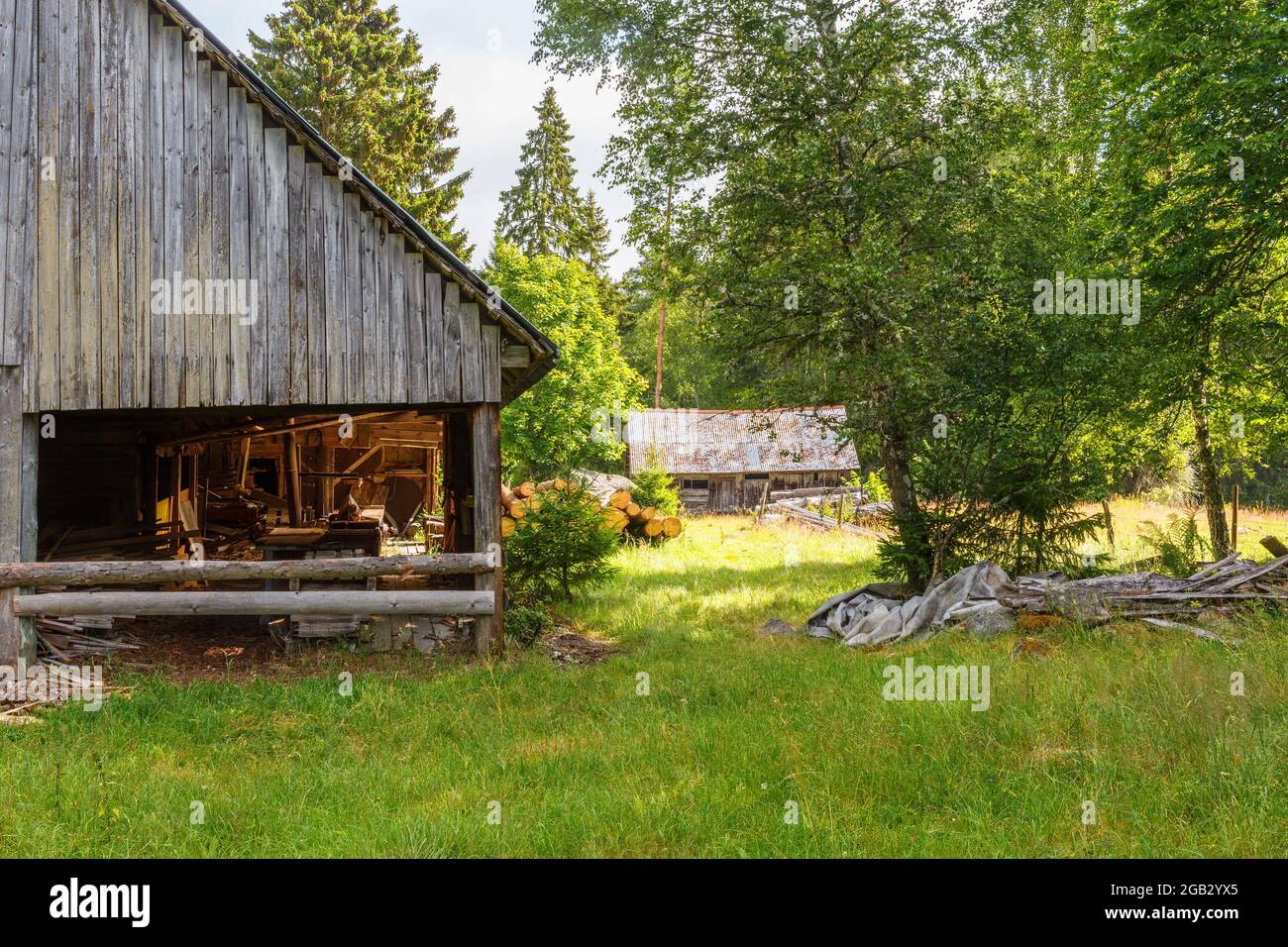 Old sawmill with timber and a shed Stock Photo - Alamy