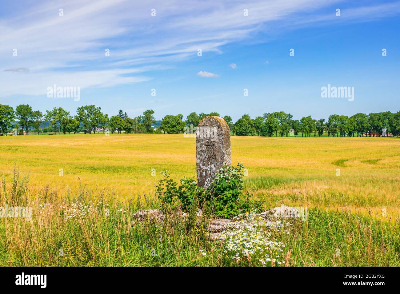 Roadside old milestone mark at a field Stock Photo - Alamy