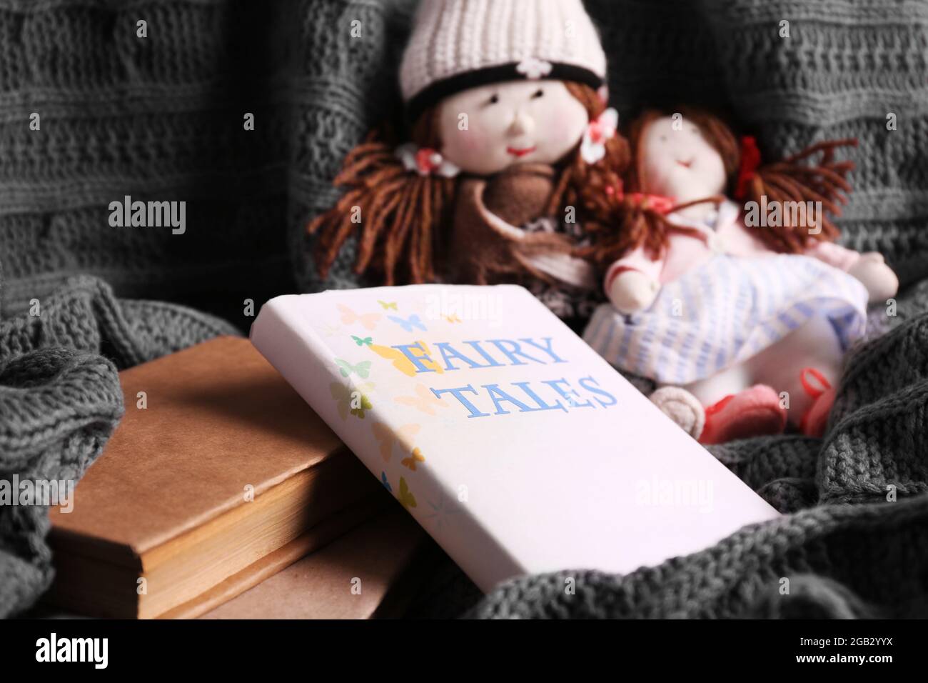 Rag dolls with fairy tales books on bedspread. Childhood concept Stock ...