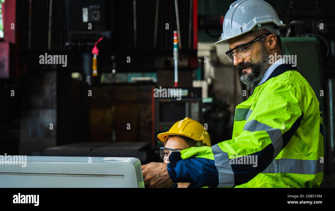 Industrial engineer wearing white helmet check, inspect and talk with ...