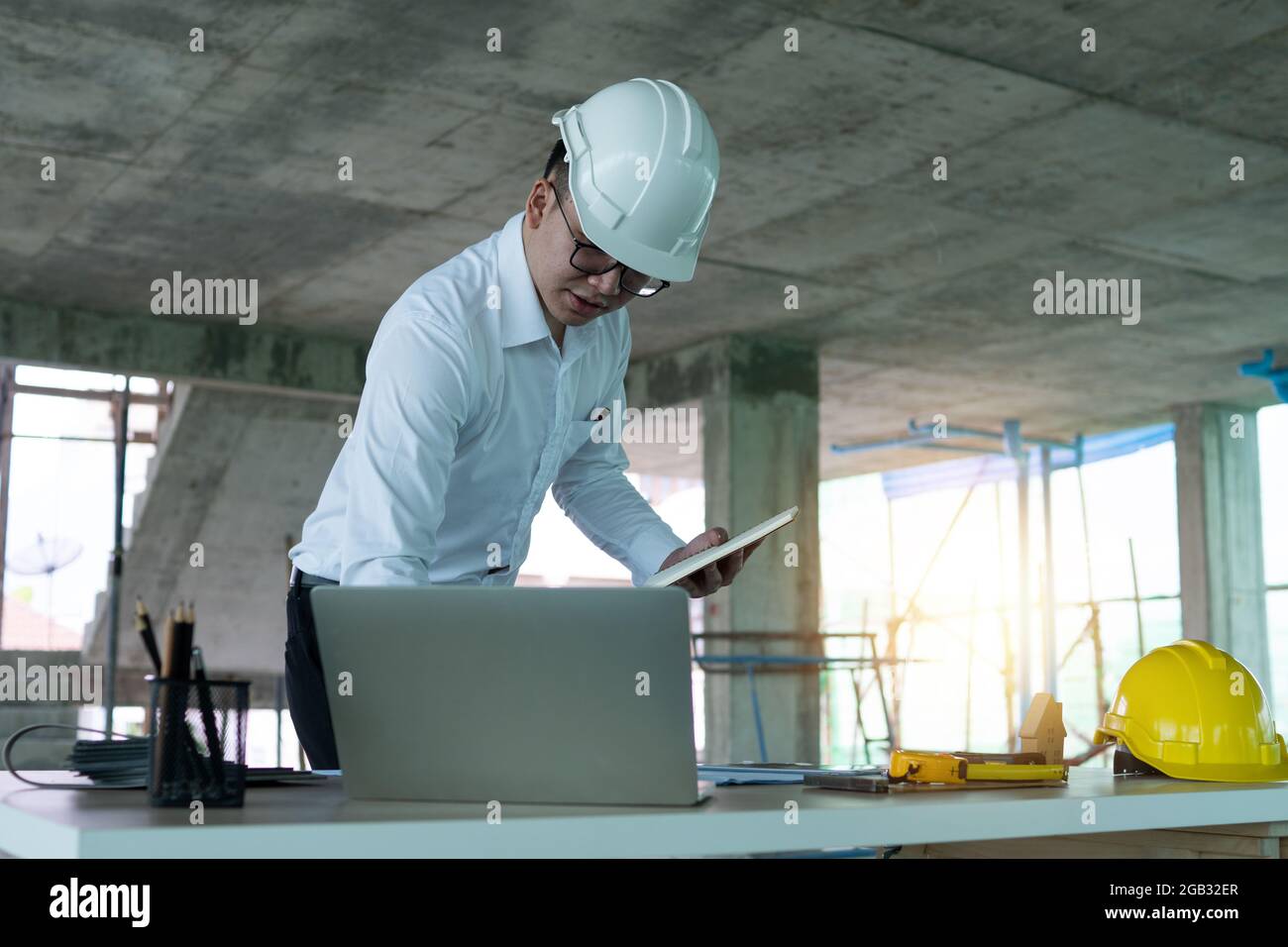 Engineer work and check on laptop in construction site, foreman wearing ...