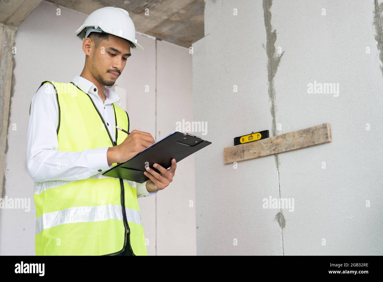 Inspector engineer wearing white helmet and reflective vest note and ...