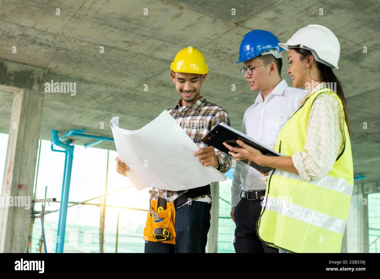 Group of engineers and architectures planning and checking building ...