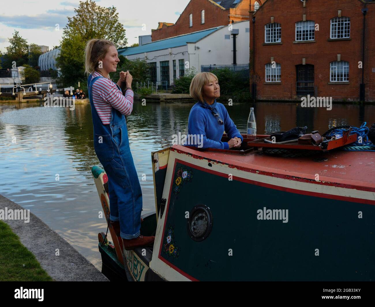 Women steering their narrow boat along the Regent's Canal at Camden, as ...