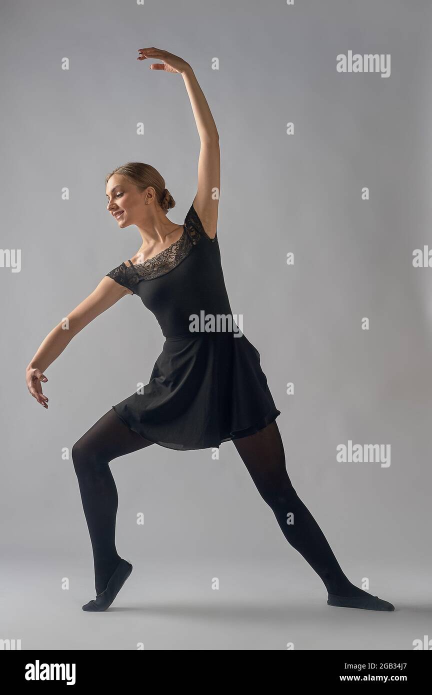 the dancer stands in a pose on a gray background Stock Photo - Alamy