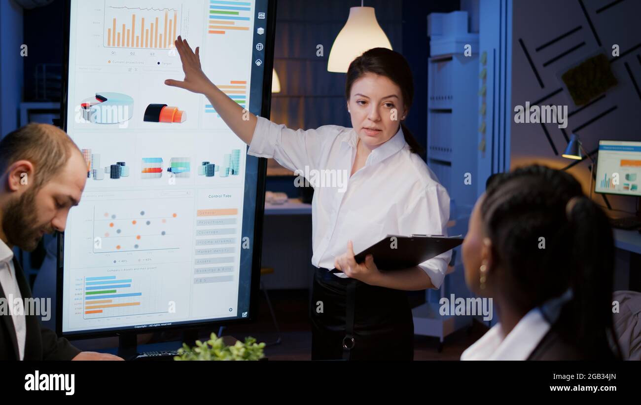 Workaholic businesswoman presenting company solution using presentation ...