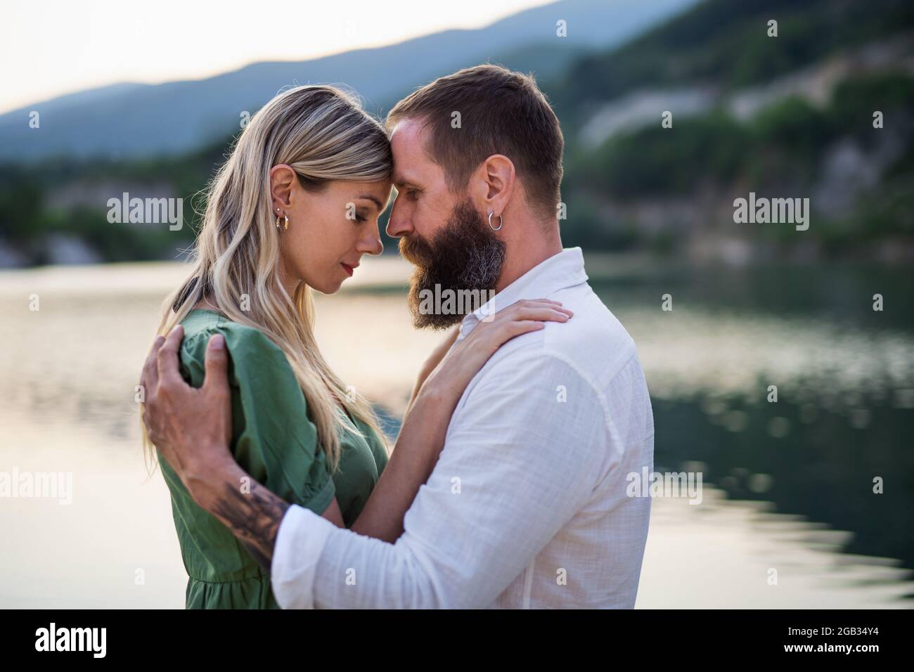 Happy mature couple in love hugging in nature Stock Photo - Alamy