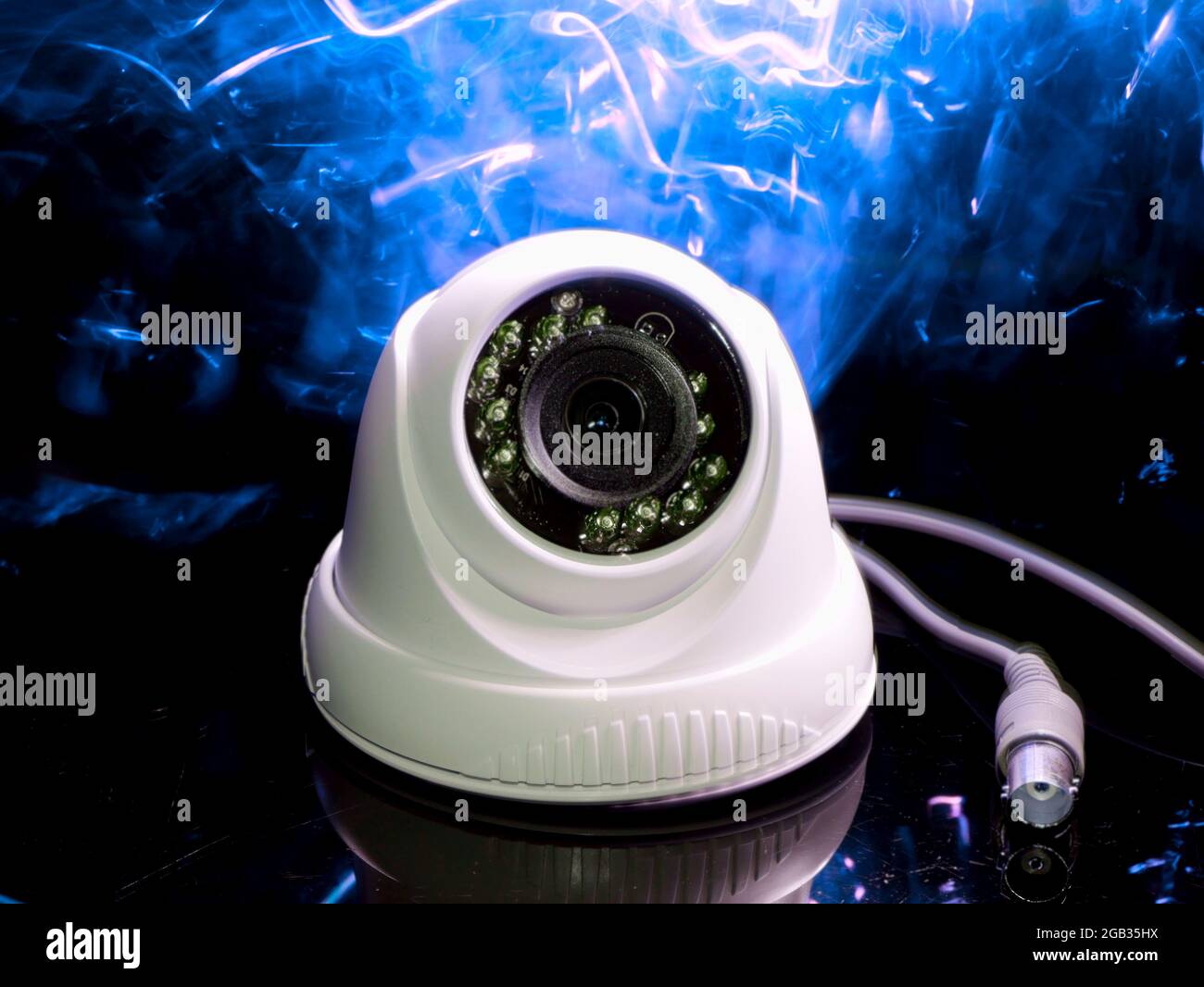Security surveillance camera isolated with blue light effect background ...