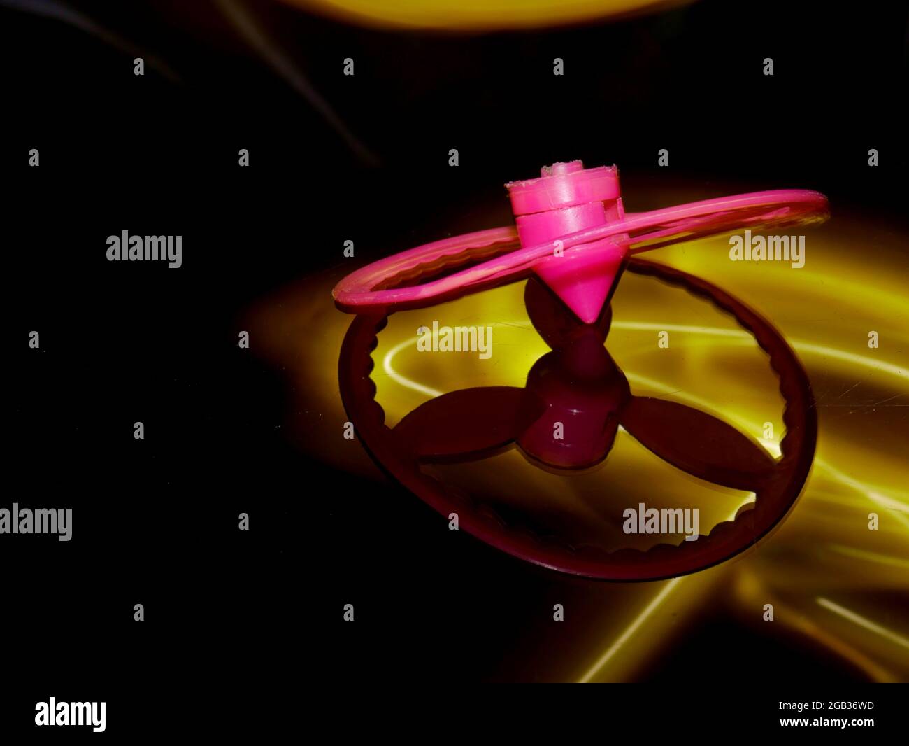 Circular shape rounding toy for kids on yellow light effect background ...