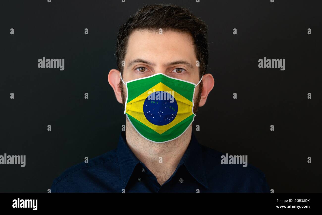 Man wearing Brazilian flag protective medical face mask. He looks ...