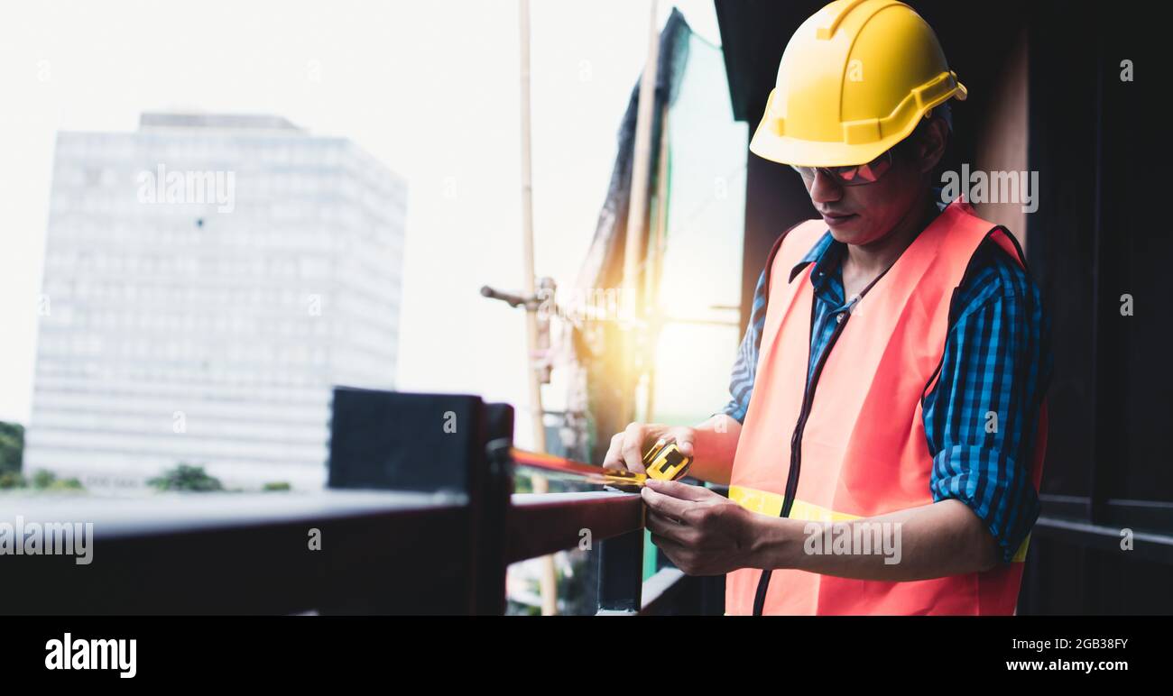 Inspector engineer wearing yellow helmet and reflective vest checking ...