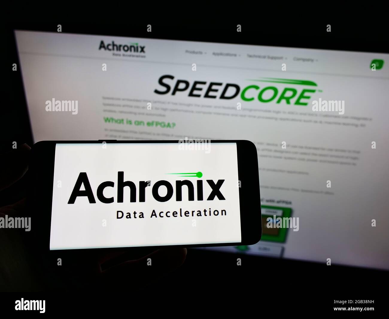 Person holding mobile phone with logo of American company Achronix Semiconductor Corp. on screen ...