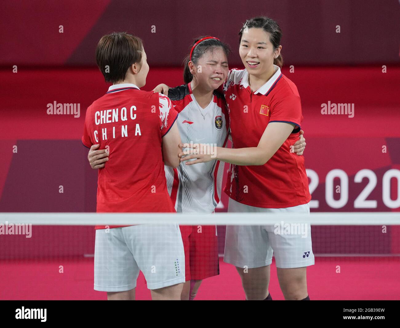 Tokyo, Japan. 2nd Aug, 2021. Chen Qingchen (L)/Jia Yifan (R) of China hug Greysia Polii of ...