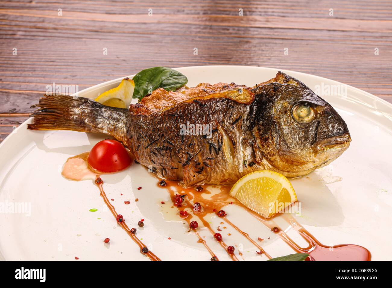 Stuffed dorada fish vith vegetables and cheese Stock Photo - Alamy