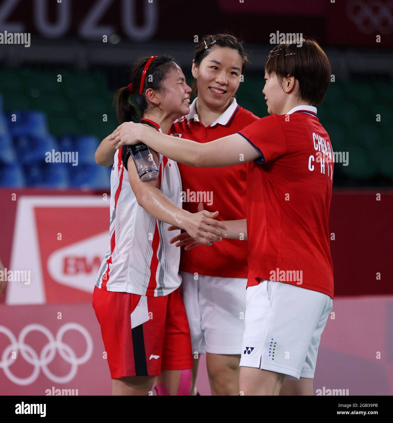 Tokyo, Japan. 2nd Aug, 2021. Chen Qingchen (R)/Jia Yifan (C) of China hug Greysia Polii of ...
