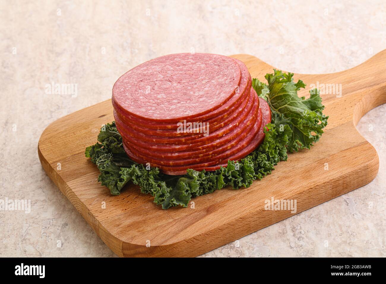 Sliced salami pork sausage snack over board Stock Photo - Alamy