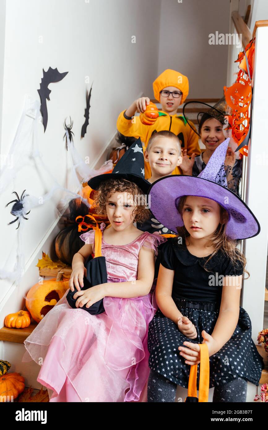 Halloween holiday party for children. Kids in costumes on staircase ...