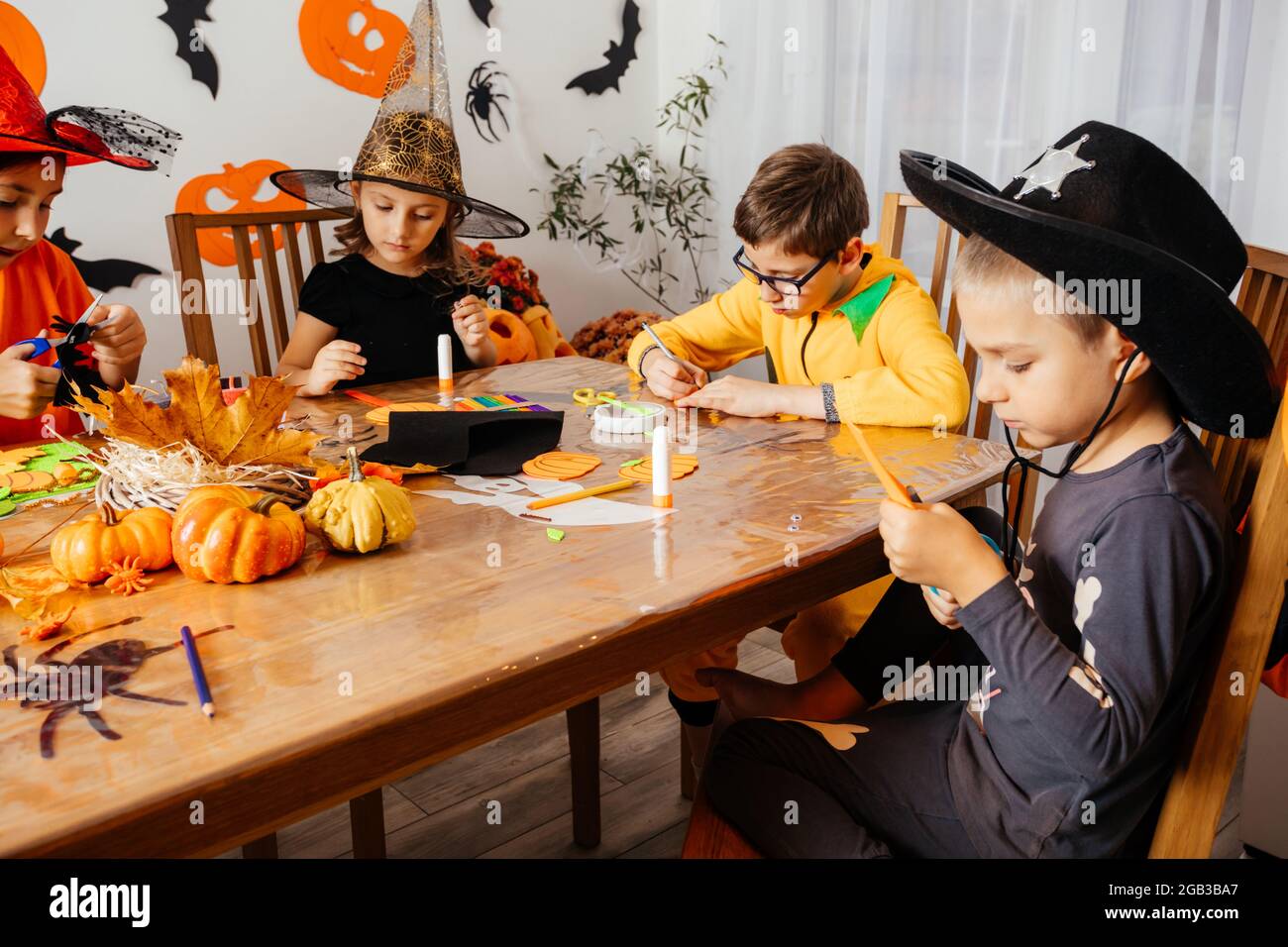Primary school kids with smiling teacher children learning at school hi ...