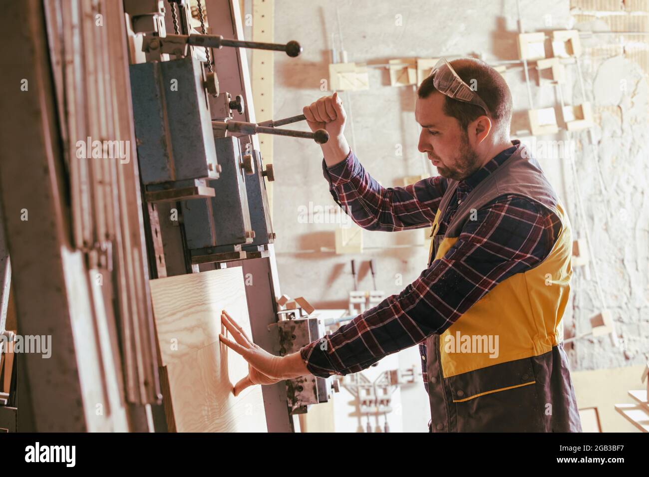 Process of making furniture with help of manual press Stock Photo - Alamy