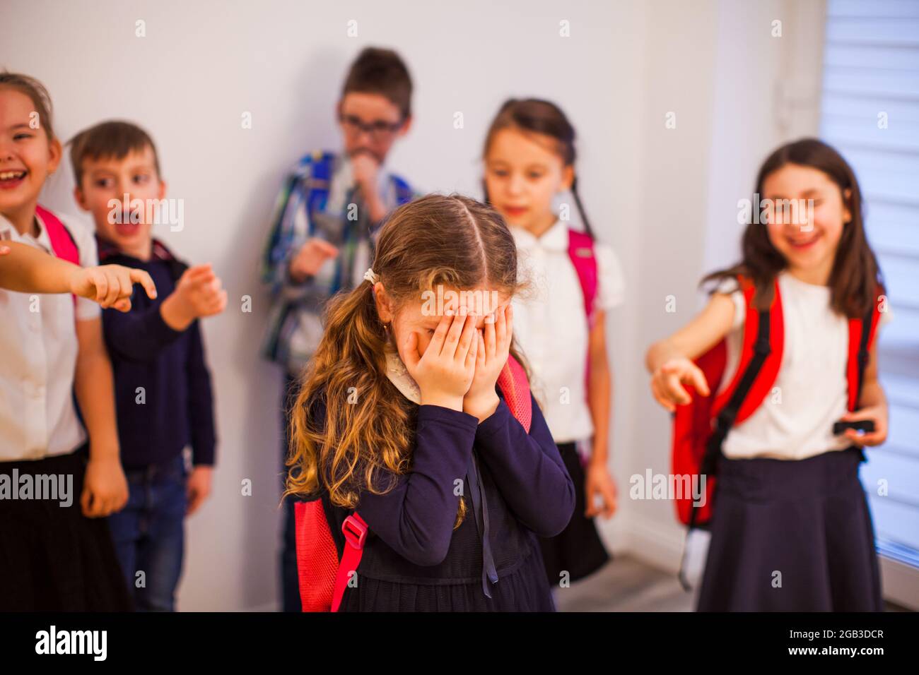 The classmates point to the boy and laugh at him Stock Photo - Alamy