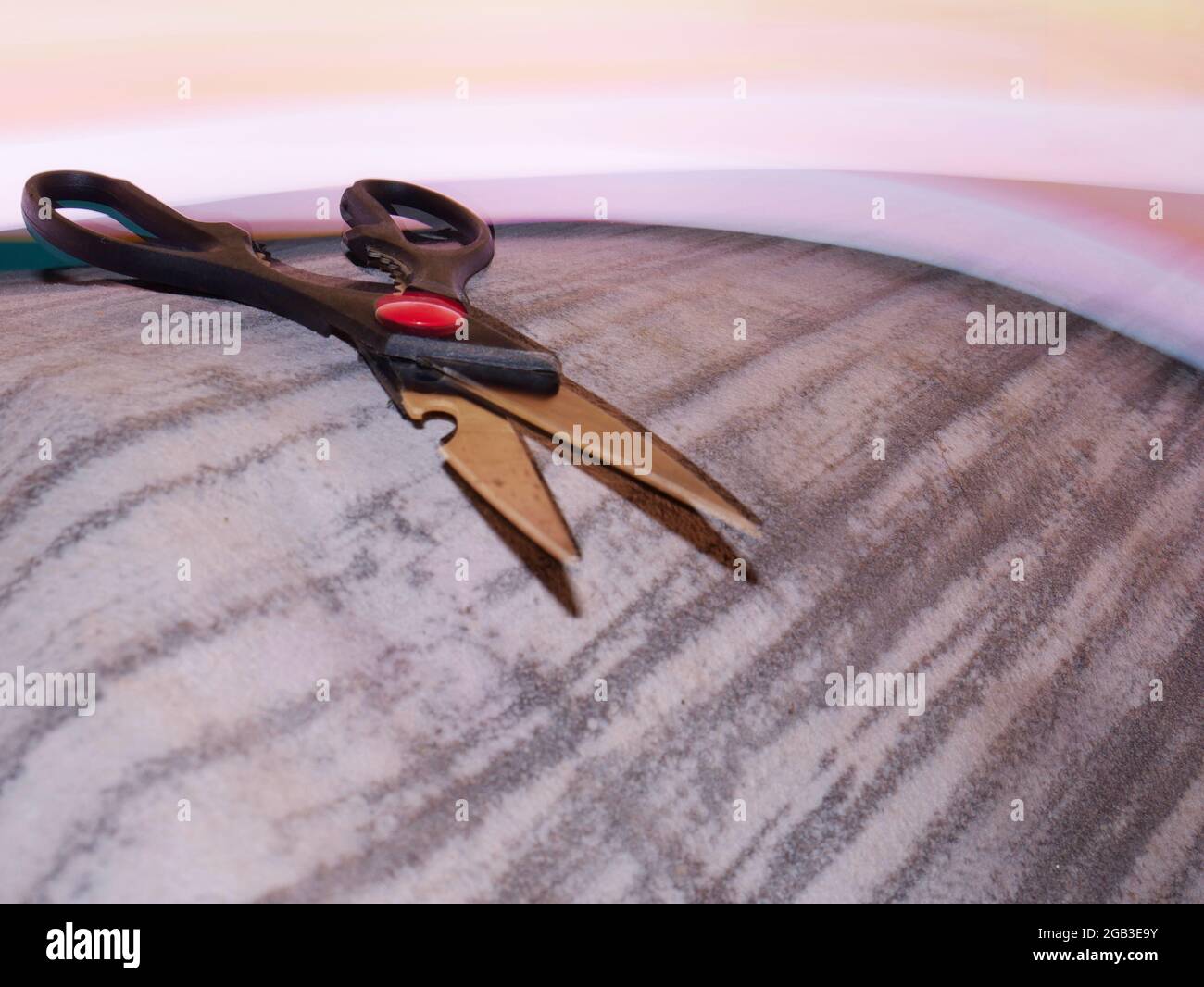 Scissor kept on mat with background light effect Stock Photo - Alamy