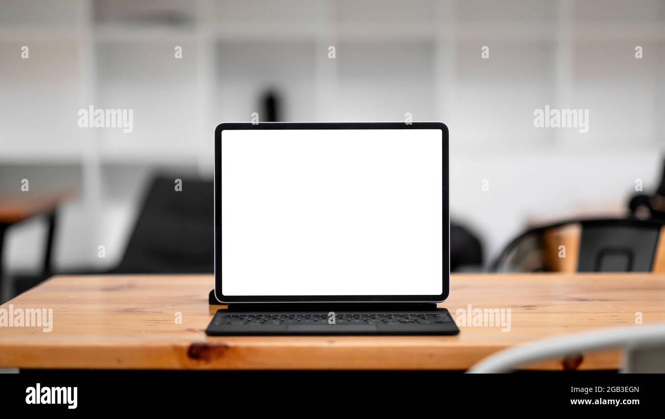 Computer tablet with blank white screen on wooden workspace Stock Photo ...