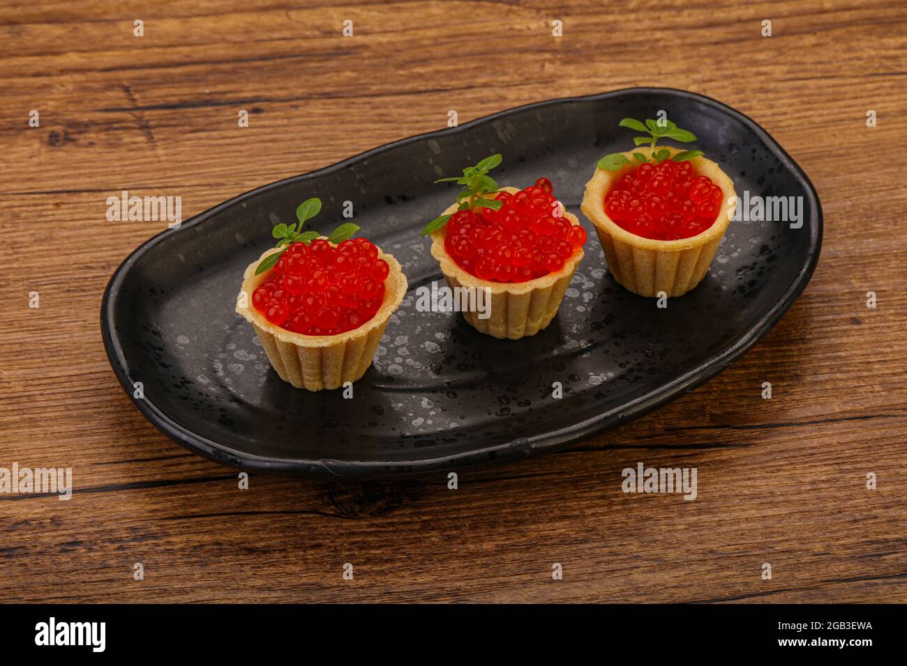 Apetizer - tartlet with red caviar snack Stock Photo - Alamy