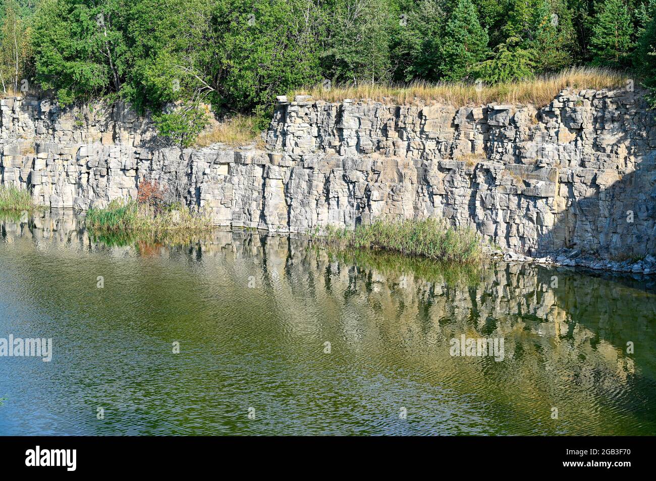 open pit filled with water and high cliffs Stock Photo - Alamy