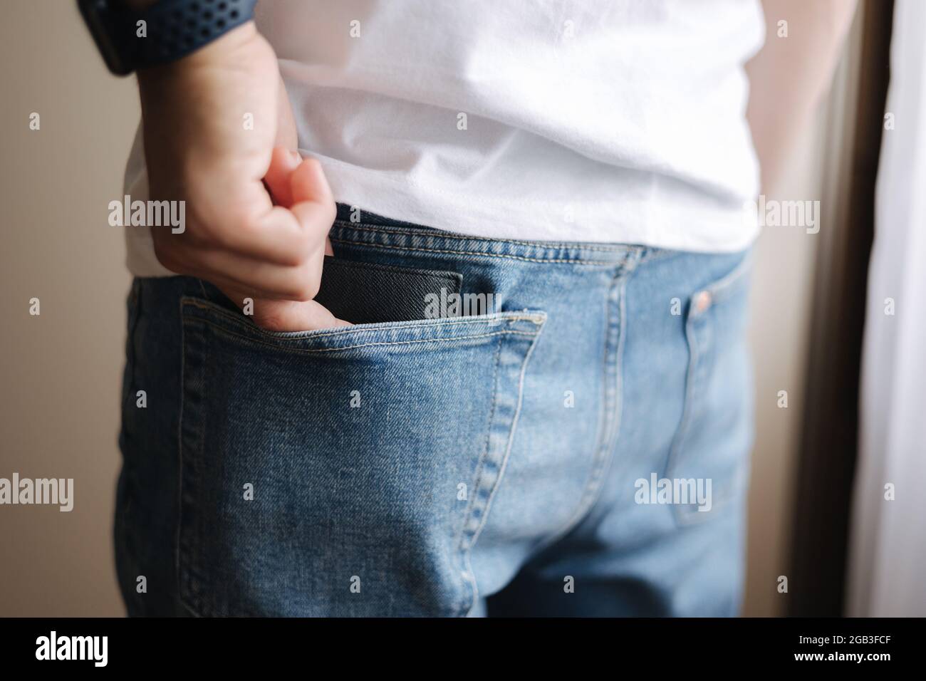 Back view of man taking wallet from back pocket Stock Photo - Alamy