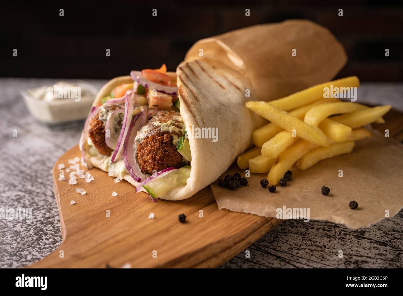 doner kebab, a shawarma in a pit of fresh vegetables and meat. with ...