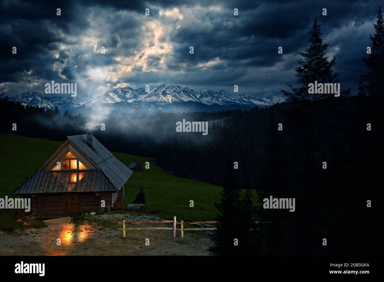 highlander hut with smoke from a fireplace against the backdrop of a ...