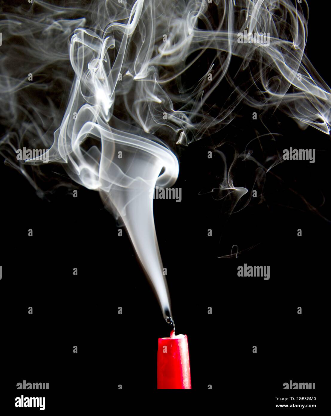 wisp of smoke rises from an extinguished candle Stock Photo - Alamy
