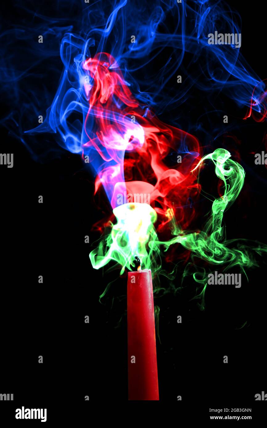 extinguished candle with red, green and blue smoke Stock Photo - Alamy