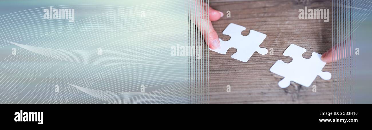 Hands joining two puzzle pieces, teamwork concept. panoramic banner ...